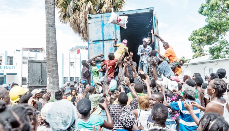 New Age | Desperate Haitians loot aid convoys